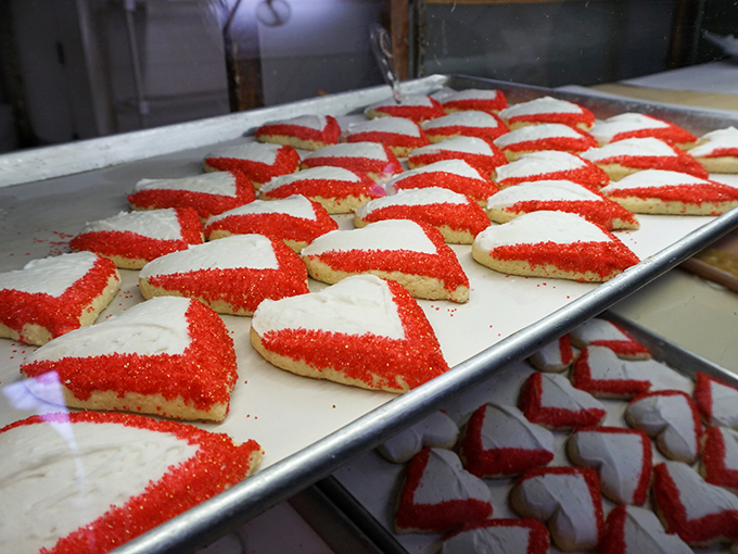 Heart-shaped cookies proving that love really does come in red and white sprinkled packages.