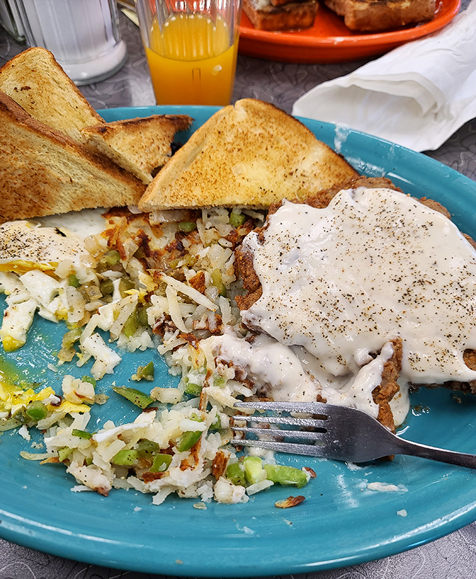 Country fried potatoes mingling with perfectly seasoned eggs and toast&mdash;a breakfast trinity that would make even non-morning people set an alarm.