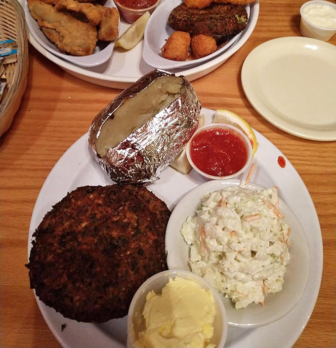 This isn't just a crab cake&mdash;it's a golden-brown disk of maritime perfection, keeping company with creamy coleslaw and a baked potato in foil.
