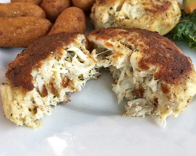 The perfect Maryland crab cake&mdash;mostly crab, minimal filler, maximum flavor. Breaking it open reveals the seafood equivalent of striking gold.
