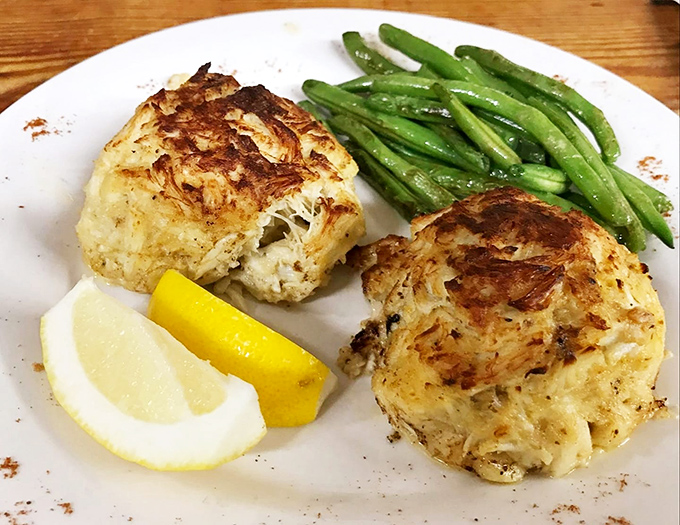 Behold the crown jewels: crab cakes so sublime they inspire road trips, featuring premium meat with minimal filler.