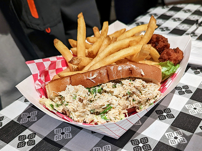 The crab roll arrives like a seafood celebration—tender, sweet crab meat piled high on a toasted roll with crispy fries standing at attention alongside.