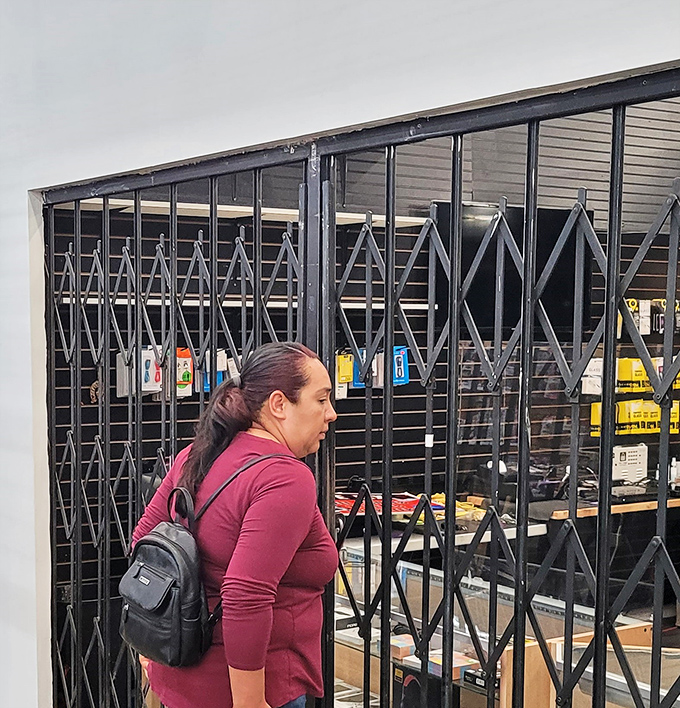 Shoppers navigate the labyrinth of vendors with determination. The serious expression says it all: treasure hunting is not for the faint of heart. 