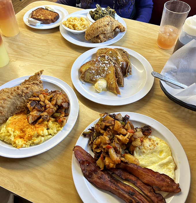A table that tells the whole story: French toast dusted with powdered sugar dreams, eggs that remember what real eggs taste like, and potatoes worth fighting over.