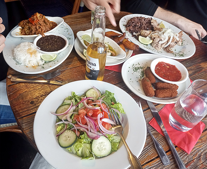 A Cuban feast spread across the table like a family reunion. The salad's just there to make you feel virtuous before diving into everything else.