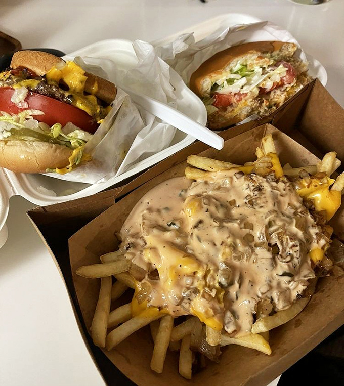 The holy trinity of comfort food: burgers, chili cheese fries, and zero pretension. This isn't a meal&mdash;it's edible therapy served in unpretentious cardboard containers.