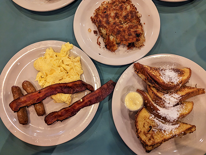 The holy trinity of breakfast perfection&mdash;golden scrambled eggs, sausage links with that satisfying snap, and French toast dusted with powdered sugar that'll make you forget your diet resolutions.