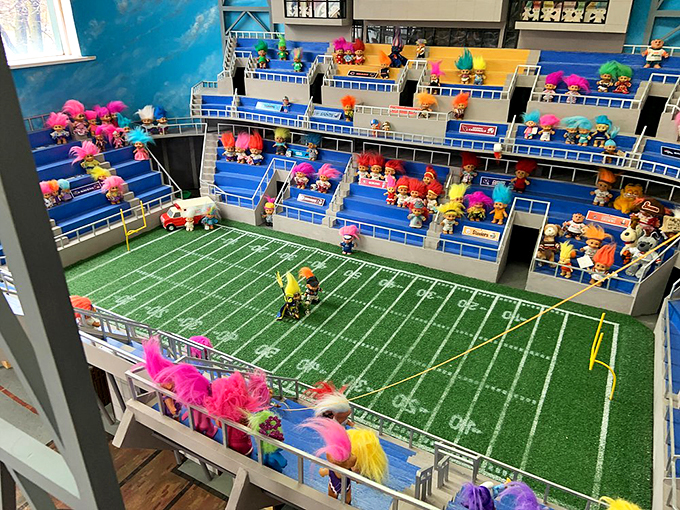 A miniature football stadium where trolls cheer eternally, proving sports fans come in all sizes.