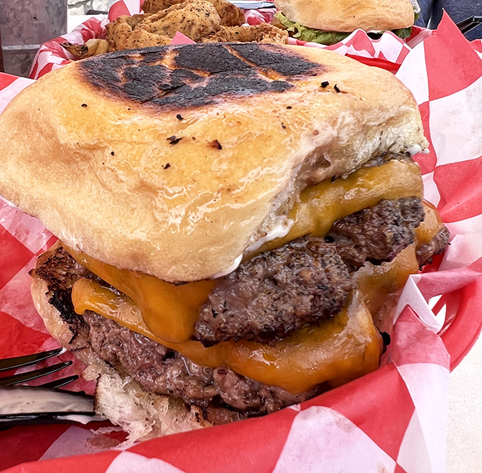 This isn't just a burger; it's an engineering marvel. The melted cheese cascading down those patties is performing a beautiful gravity-defying dance. 