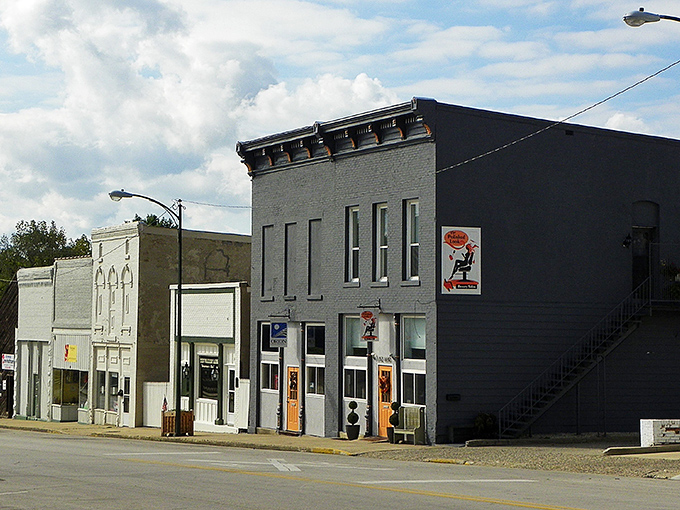 Downtown storefronts painted in muted tones create a streetscape that feels like stepping into a Midwestern time capsule.