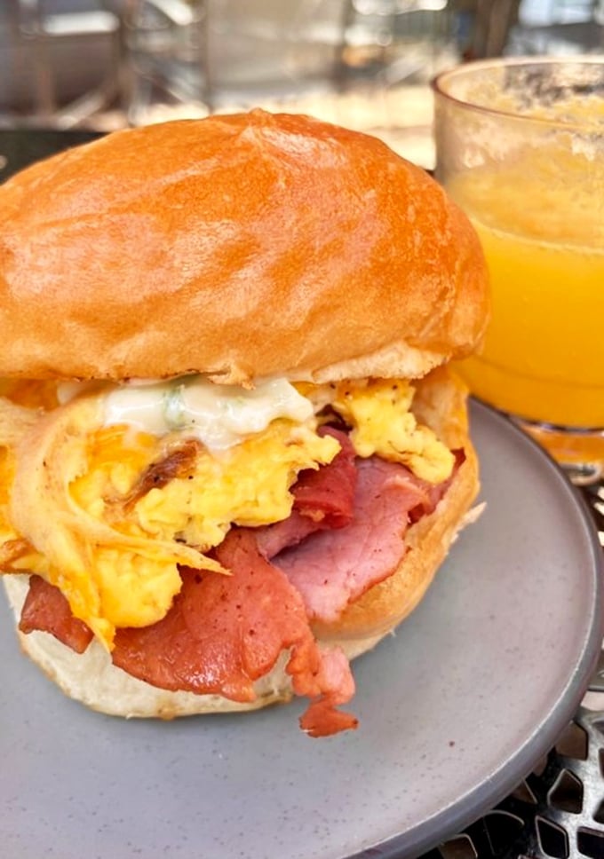 The sandwich that launched a thousand road trips. That golden brioche bun cradling eggs and meat like they're precious cargo &ndash; which, let's be honest, they are.