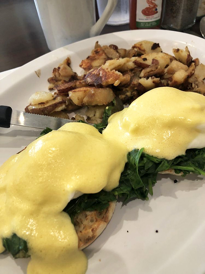 Eggs Benedict that puts hotel brunch buffets to shame. That hollandaise sauce looks like liquid sunshine cascading over spinach mountains.