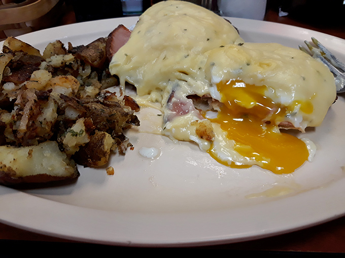 Eggs Benedict with perfectly runny yolks cascading over ham and English muffins. The hash browns aren't an afterthought&mdash;they're a supporting star.