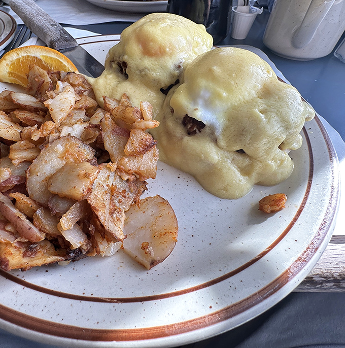 Eggs Benedict that answers the eternal question: "What would breakfast look like if it wore a tuxedo?" Home fries playing the perfect supporting role.