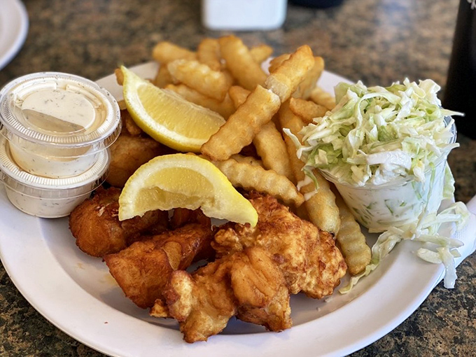 The star attraction: golden-battered fish with crispy fries, fresh slaw, and tartar sauce that would make a New Englander weep with joy.
