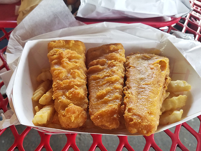 Golden fish planks nestled atop a bed of fries &ndash; seafood that's traveled inland but hasn't forgotten its crispy, delicious purpose.