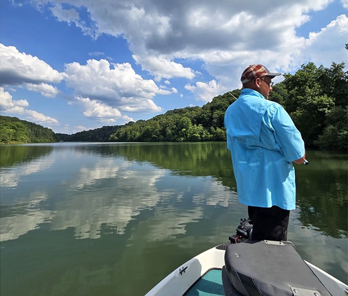 The patient angler waits. At Strouds Run, fishing isn't just about catching&mdash;it's about that perfect moment of zen on the water.
