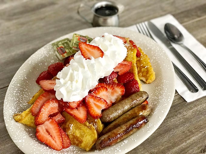 French toast that's dressed for success with strawberries, whipped cream, and sausage links—breakfast's version of formal attire.