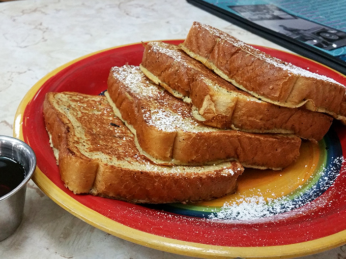 Golden-brown French toast dusted with powdered sugar&mdash;proof that simplicity, when done right, can outshine complexity every time. Maple syrup: nature's liquid gold.