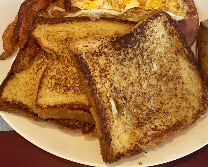 French toast so golden and perfect, it practically glows like breakfast treasure worthy of a museum display case.