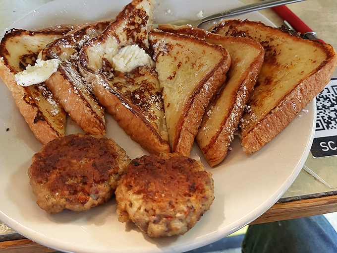 French toast that's achieved that perfect golden-brown glow, paired with sausage patties that look like they're auditioning for a breakfast commercial.