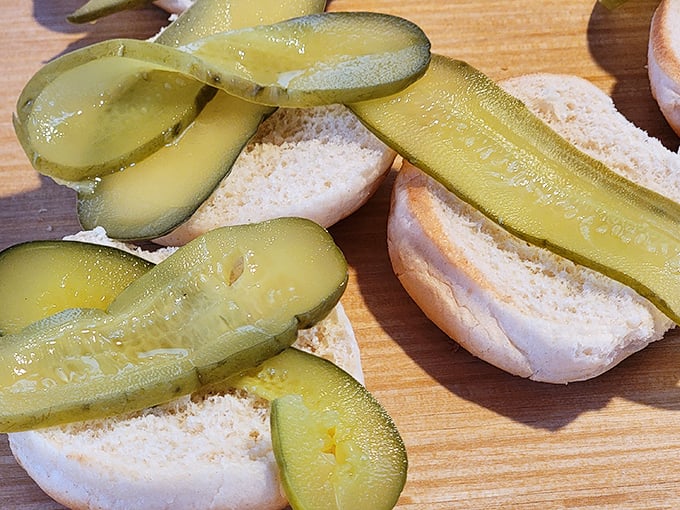 These aren't just pickle slices&mdash;they're tangy green crowns for burger royalty, waiting patiently for their moment of glory atop fresh buns.