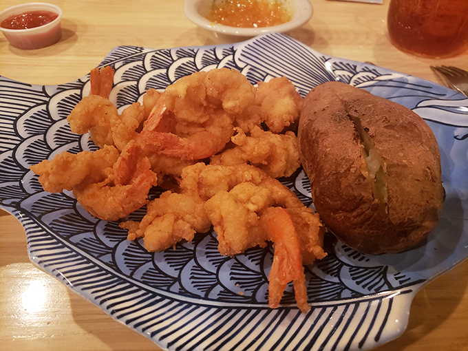 Golden-fried shrimp that crunch like your favorite childhood memory, paired with a baked potato that's practically begging to be your comfort food soulmate.