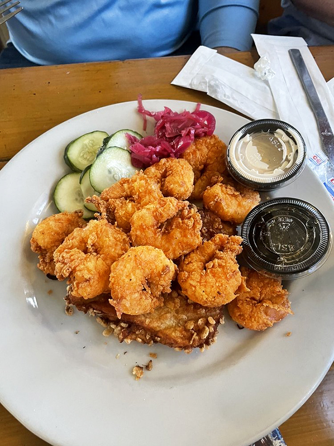 Golden-fried shrimp that snap with freshness, served with cooling cucumber slices and pickled onions &ndash; a trio that belongs together like retirees and early bird specials.