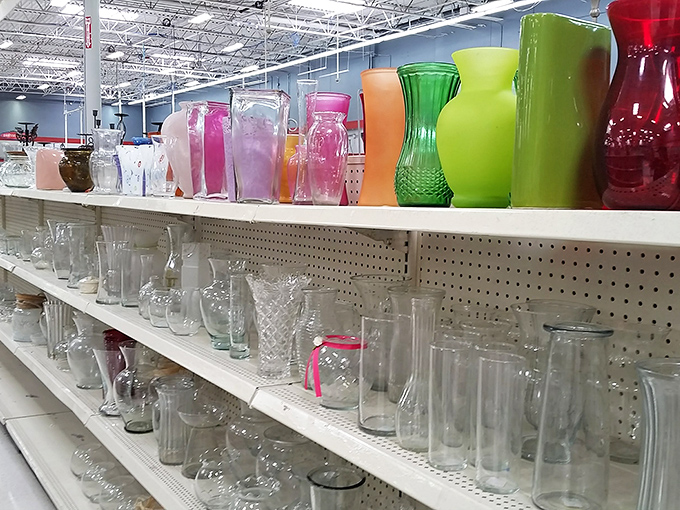 A rainbow of glassware stands at attention, waiting for second acts at dinner parties. These aren't just vessels; they're conversation starters with previous lives.