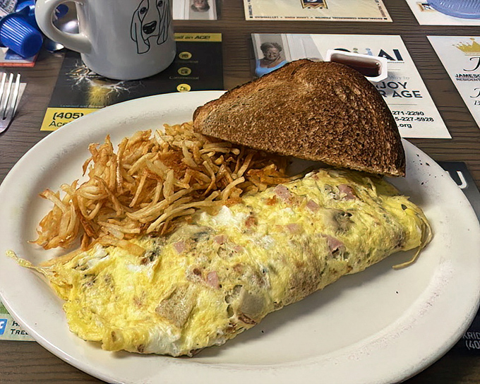 This isn't just an omelet &ndash; it's a masterclass in breakfast architecture, with perfectly folded eggs embracing ham and cheese like old friends reuniting.