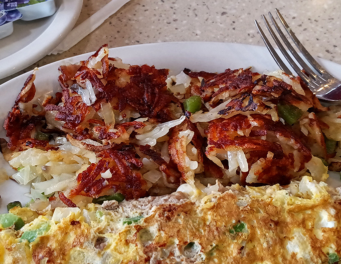These perfectly crispy hash browns and fluffy eggs prove that sometimes the simplest diner classics deliver the most satisfaction. Comfort food engineering at its finest.