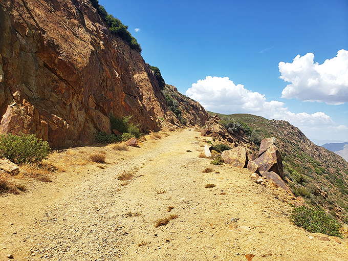 The path less traveled offers its own rewards. This sun-baked trail hugs the mountainside like nature's own balcony overlooking the desert below.