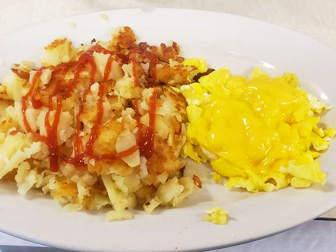 When hash browns meet ketchup and eggs meet cheese, magic happens. This plate is the breakfast equivalent of finding money in an old jacket pocket.
