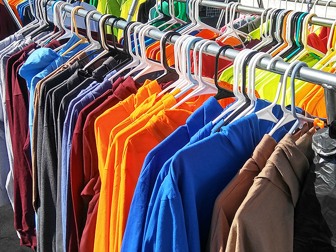 A rainbow of t-shirts hanging like colorful soldiers &ndash; each one ready to become someone's favorite weekend warrior uniform.