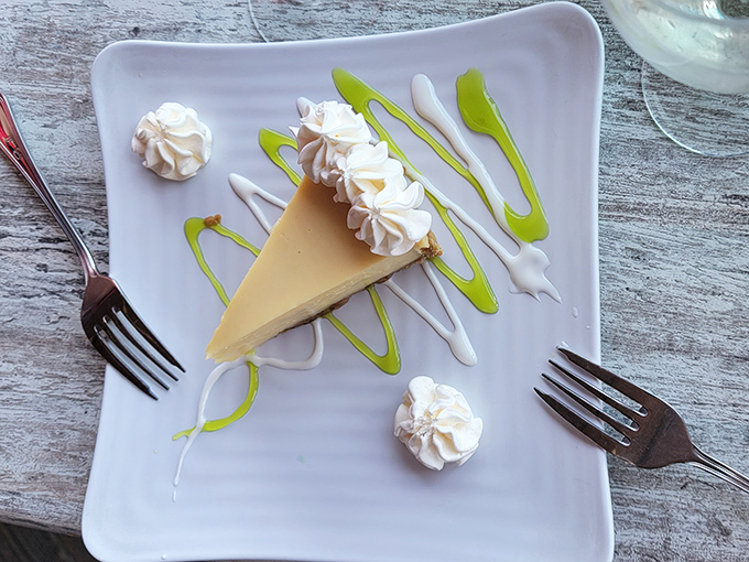 Key lime pie that strikes the perfect balance between sweet and tart. That artistic green drizzle? Pure Florida showmanship.