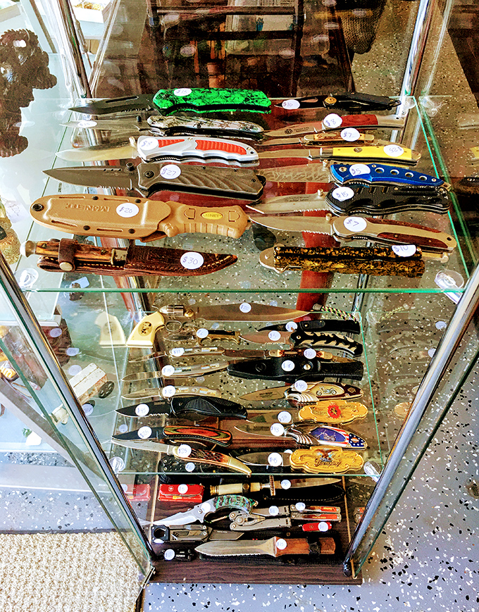 This knife display case isn't just selling cutlery &ndash; it's offering conversation pieces with handles more colorful than a Florida sunset.