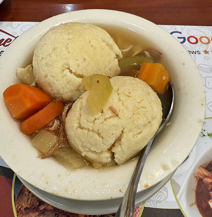 Fluffy matzo balls floating in golden broth like edible clouds that somehow cure everything that ails you.