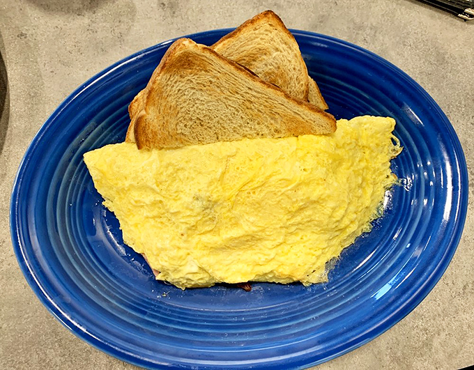 Behold the breakfast of champions &ndash; a fluffy omelet alongside perfectly toasted bread. Simple pleasures executed with the precision of a culinary Olympic event.