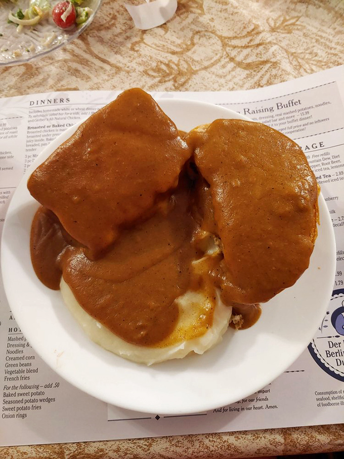 Meatloaf that would make your grandmother jealous, smothered in gravy that cascades over cloud-like mashed potatoes. This isn't food; it's an edible hug.