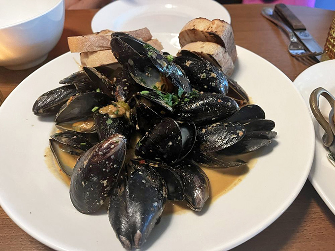 These mussels aren't just showing off their muscles &ndash; they're swimming in a broth so good you'll be plotting ways to drink it unnoticed.