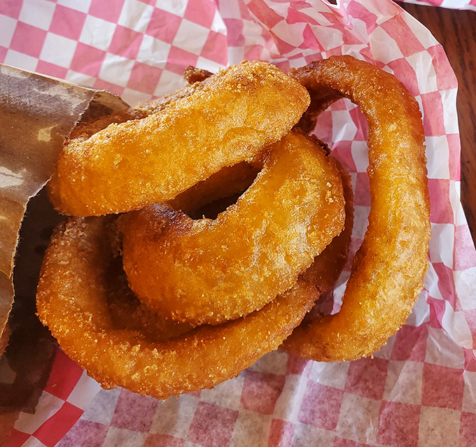 Golden onion rings with that perfect crunch-to-softness ratio. The kind that make you wonder why anyone bothers with those fancy appetizers at upscale restaurants.