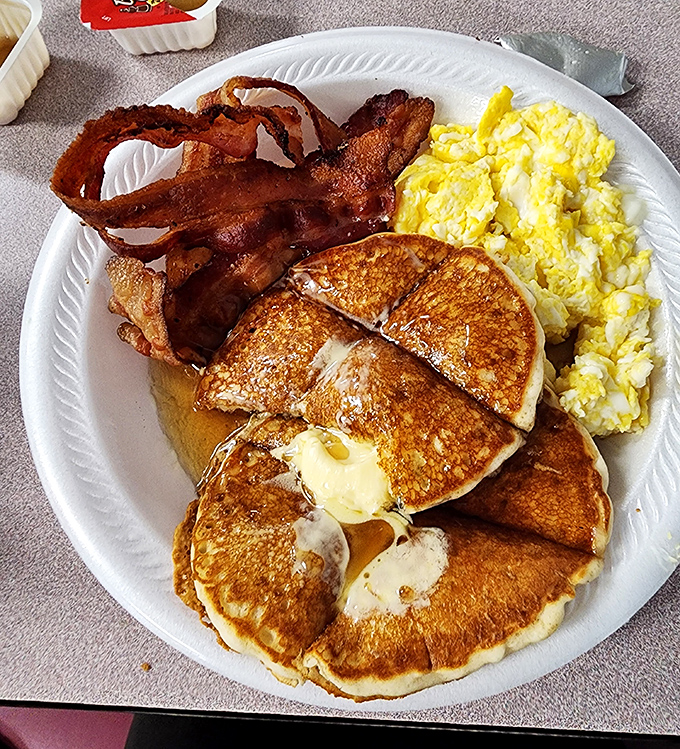 Golden pancakes with a pat of melting butter, crispy bacon, and fluffy eggs&mdash;the breakfast trinity that makes mornings worth facing.