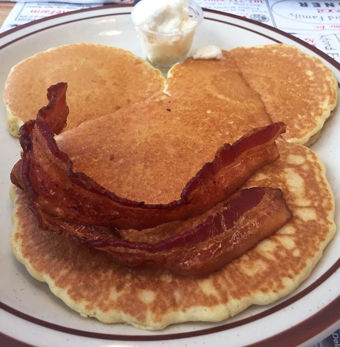 Pancakes so perfectly golden they belong in Fort Knox, topped with bacon that's achieved that magical balance between crispy and chewy. Breakfast nirvana exists!