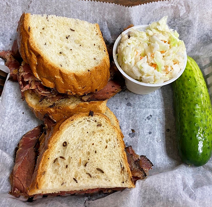 When a sandwich requires structural support from a pickle, you know you've found the real deal. Coleslaw as a side? Perfection.