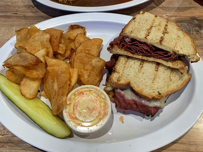 The sandwich that makes you pause mid-conversation. Thick-cut pastrami nestled between grilled bread with house-made chips standing guard.