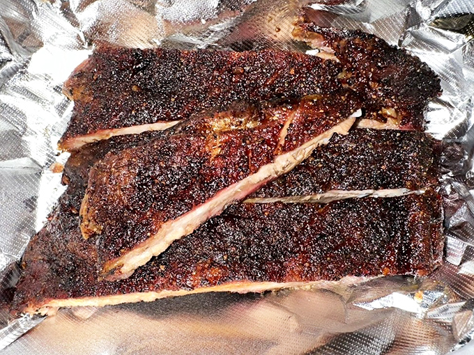 These ribs wear their spice rub like a badge of honor. The crust speaks of patience, smoke, and barbecue wisdom passed down through generations.
