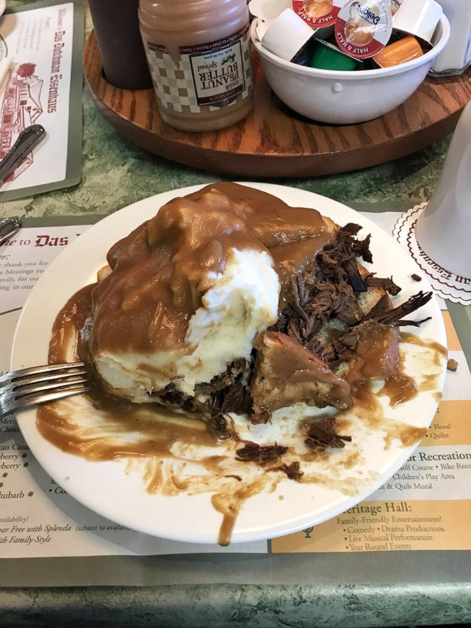 A plate of pot roast so tender it practically surrenders to your fork, smothered in gravy that deserves its own fan club.