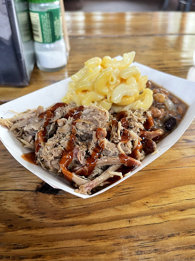 Pulled pork and mac & cheese: the dynamic duo of comfort food. One forkful and suddenly all your life problems seem manageable&mdash;at least until the plate's empty.