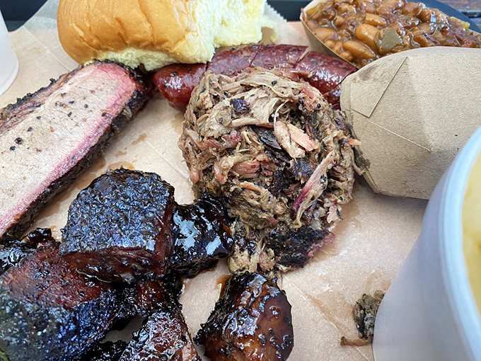The barbecue sampler that makes choosing unnecessary. Like a greatest hits album of smoke and spice, featuring that pulled pork that practically jumped onto the fork itself. 