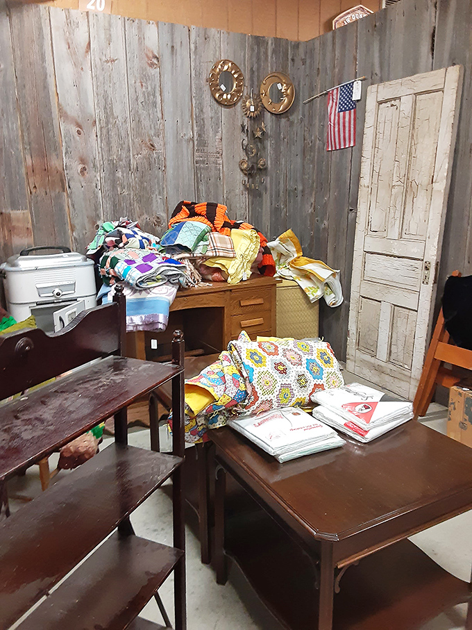 Grandma's quilts and vintage linens create a colorful tapestry of Americana against weathered barn wood walls &ndash; comfort in fabric form.